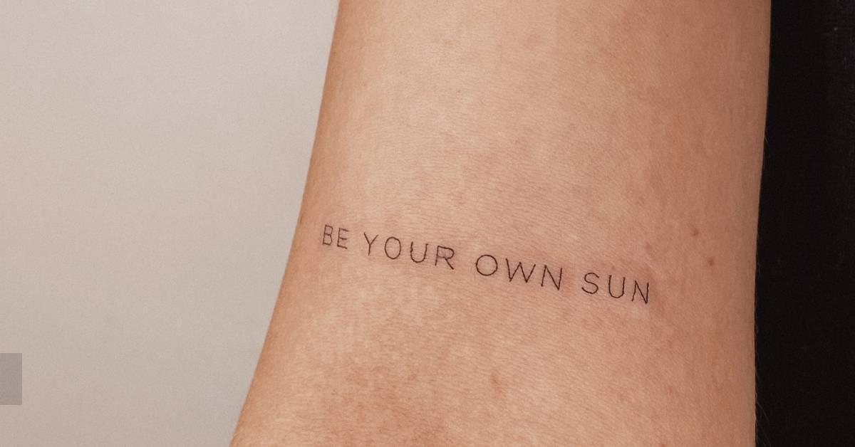 "Be your own sun" lettering tattoo located on the