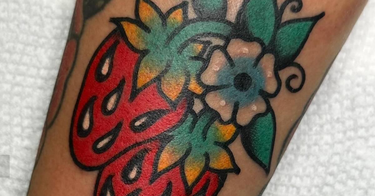 Traditional style strawberries tattoo located on the