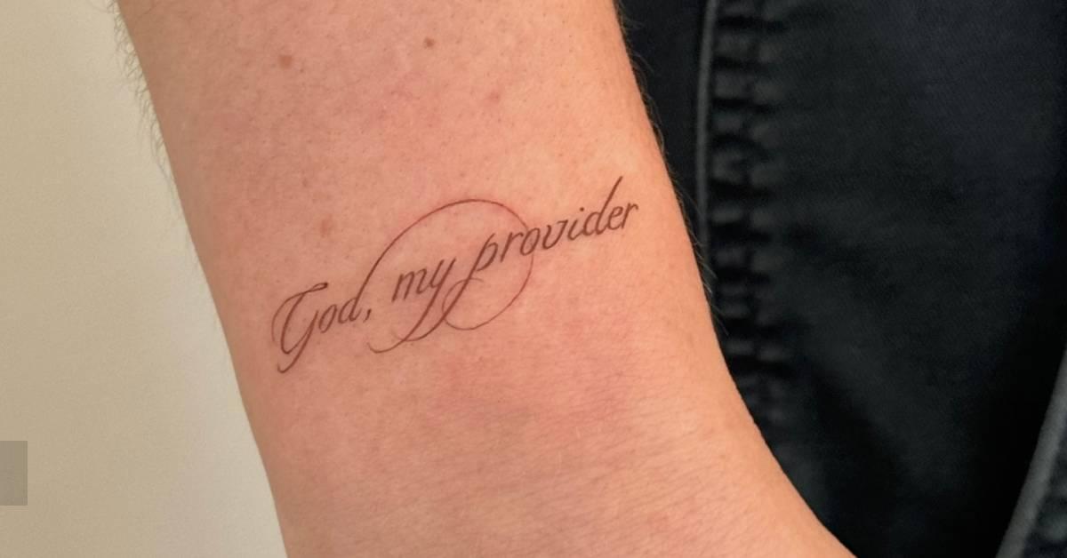 "God, my provider" lettering tattoo placed on the