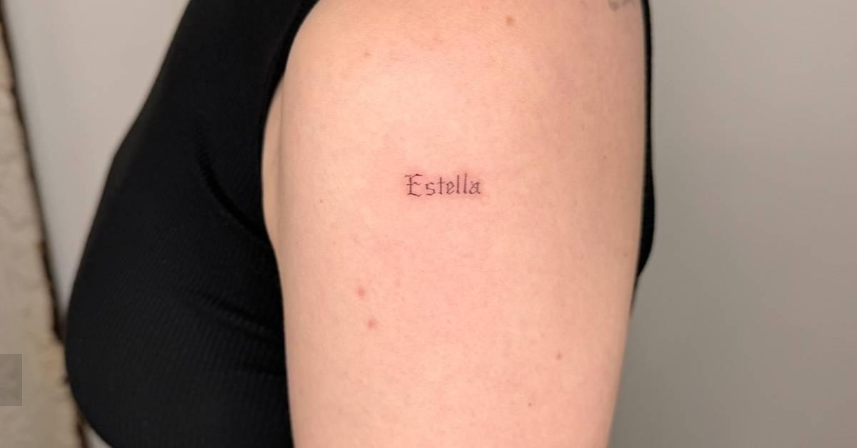 "Estella" lettering tattoo in gothic font located on