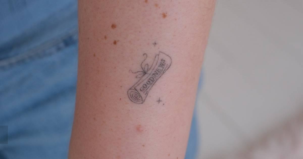 Newspaper tattoo in fine line style located on the