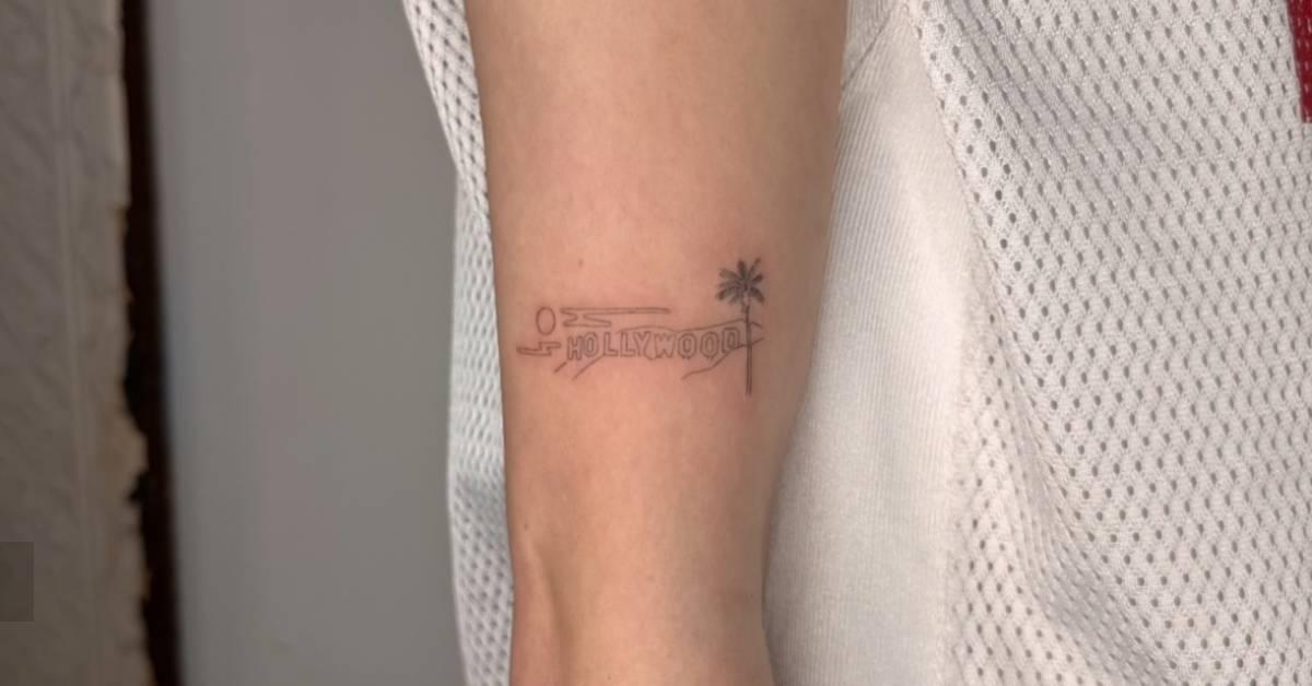 Single needle Hollywood Sign tattoo located on the