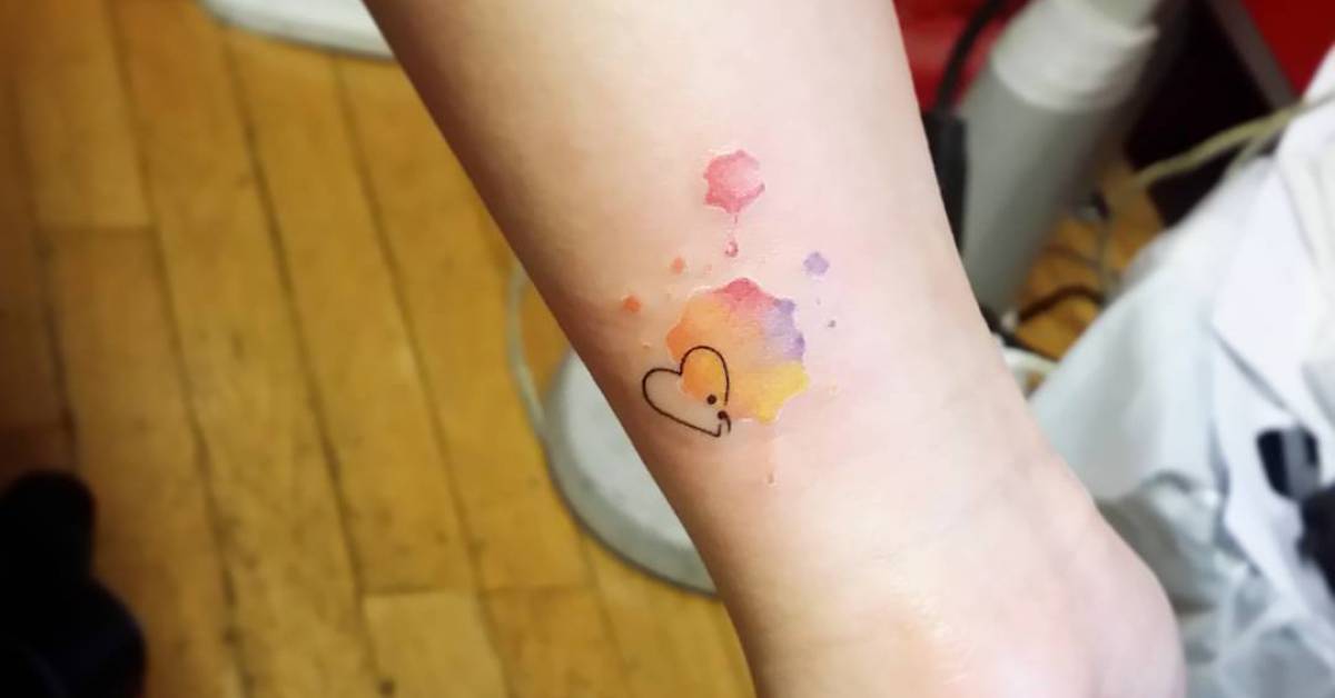Semicolon heart tattoo with a watercolor background, on