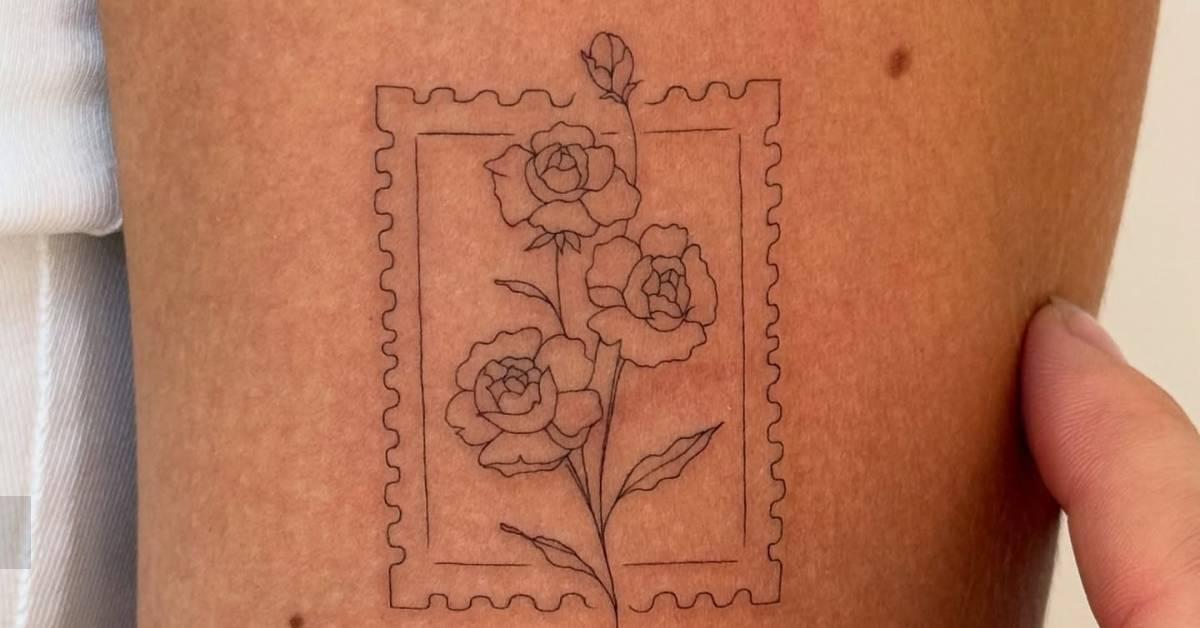 Fine line style rose stamp tattoo done on the upper