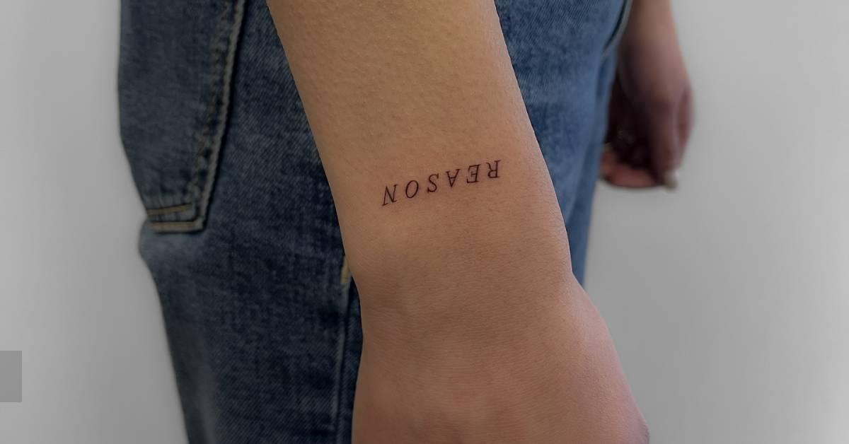 Lettering tattoo of the word "reason" located on the