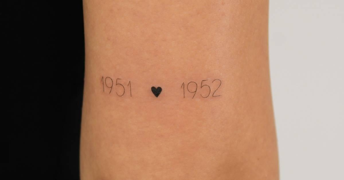 "1951" and "1952" lettering tattoo located on the