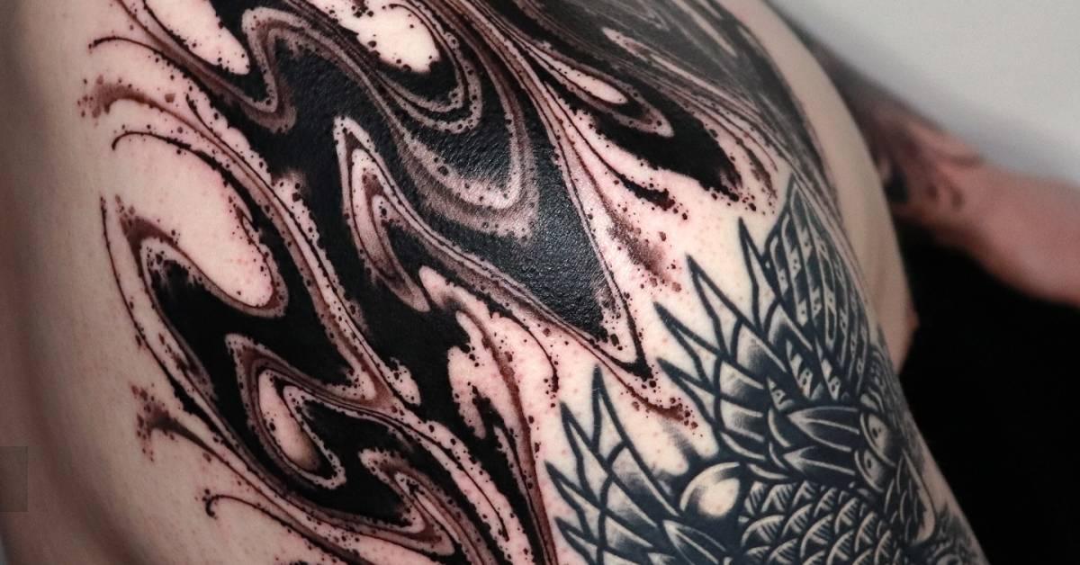 Abstract style tattoo located on the shoulder.