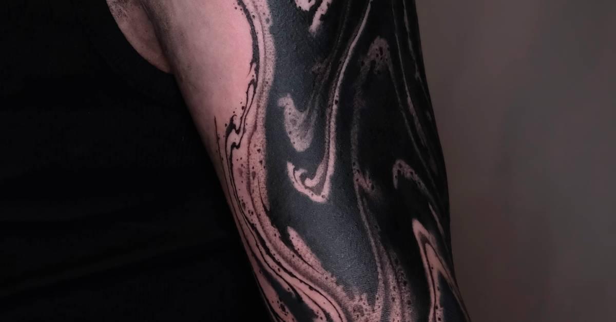Abstract half sleeve tattoo in blackwork style.