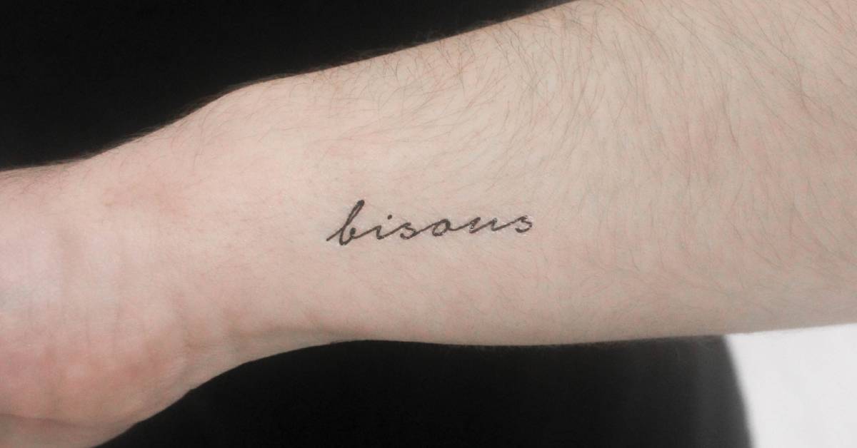 Handwritten font word "bisous" temporary tattoo located