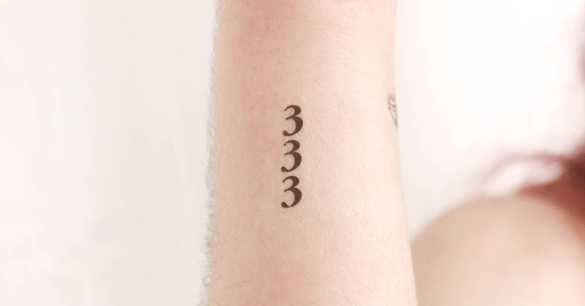 Vertical "333" temporary tattoo located on the wrist.