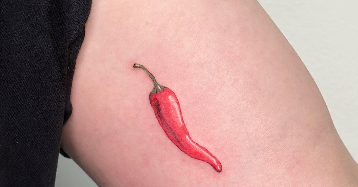 Illustrative style red chili tattoo located on the
