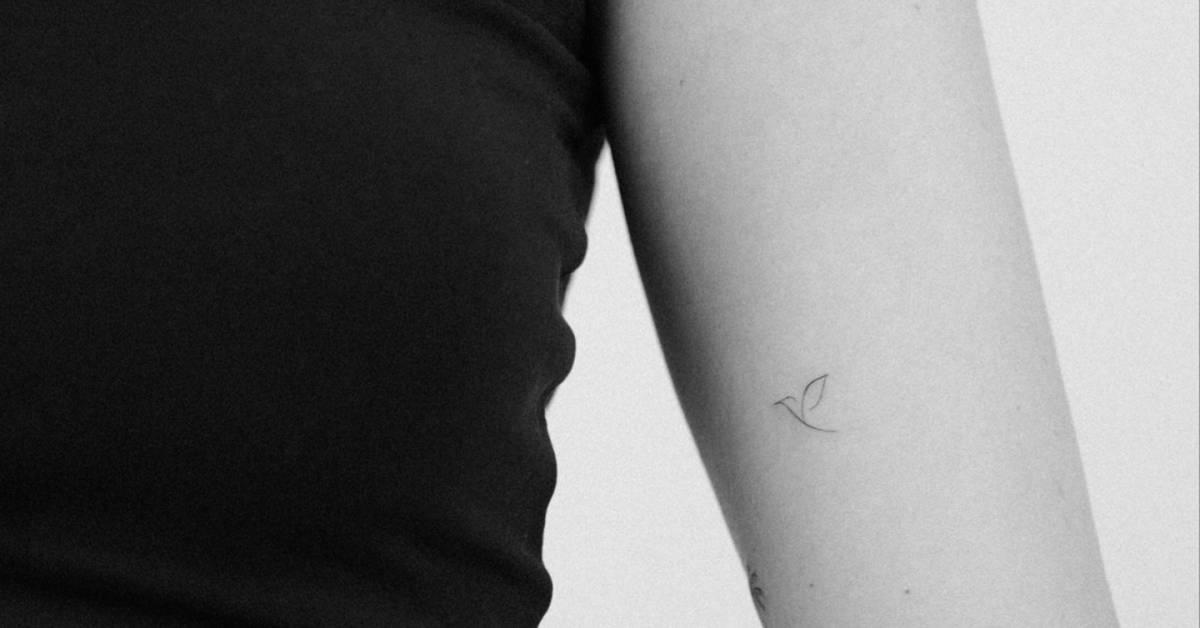 Minimalistic tiny Tatteco logo tattooed on the upper