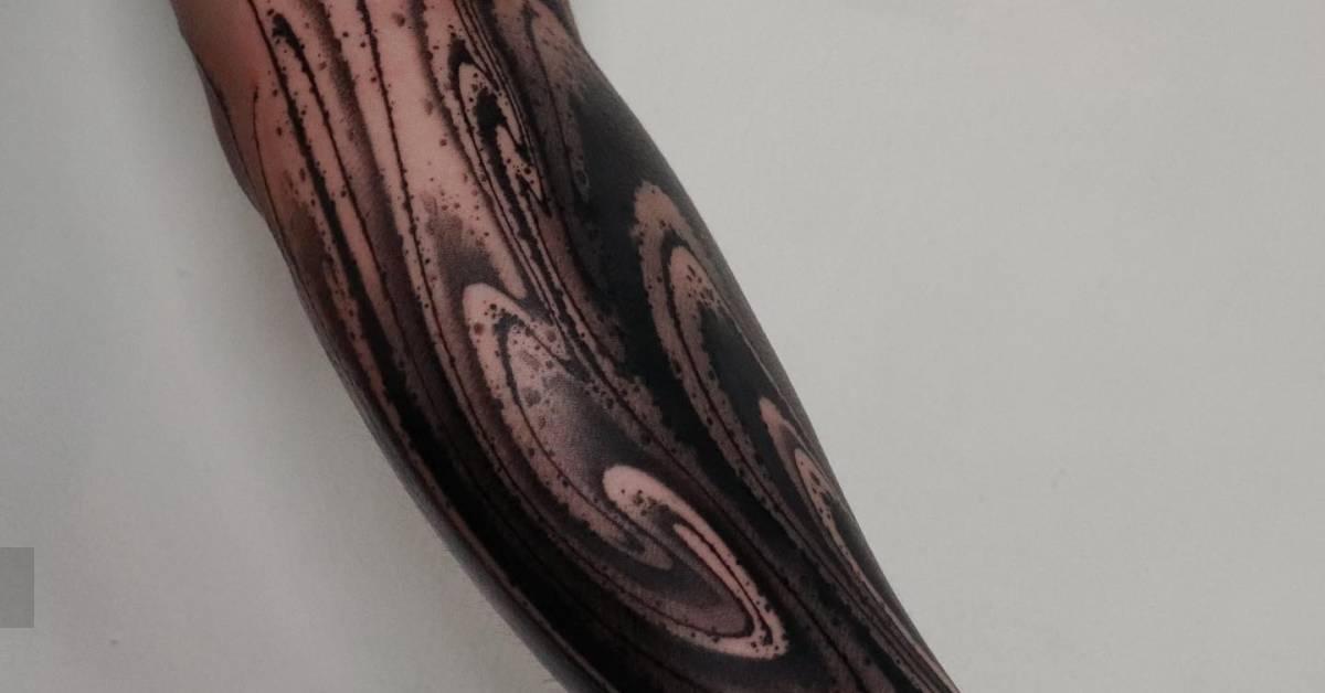 Abstract flow tattoo located on the arm.