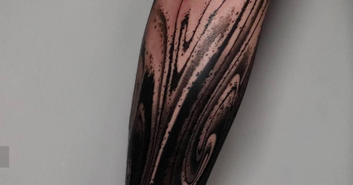Abstract flow tattoo located on the forearm.