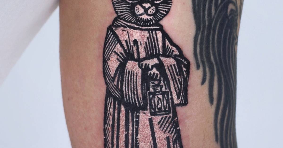 Pop art style priest cat tattoo placed on the inner