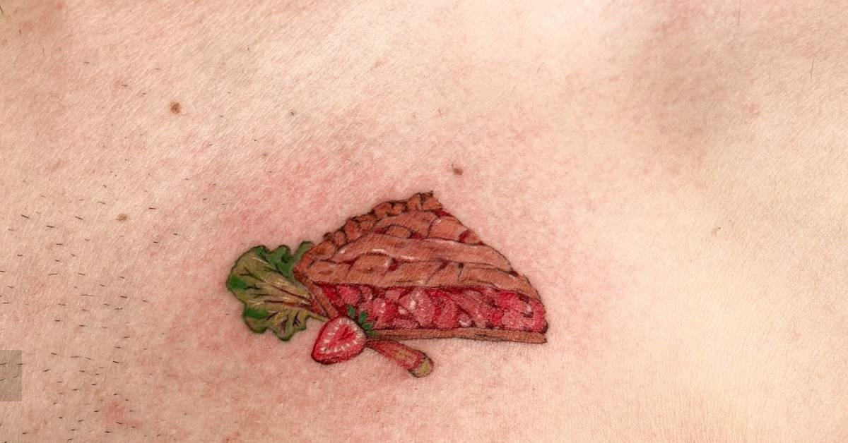 Illustrative style pie tattoo located on the chest.