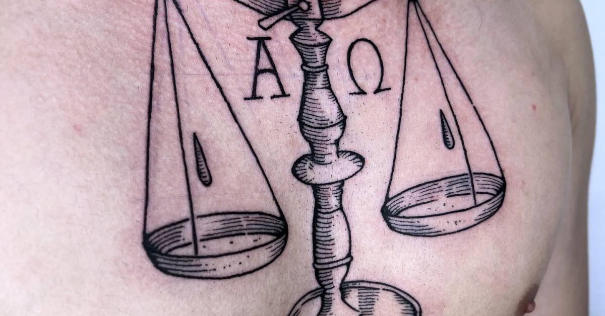 Scale tattoo in engraving style located on the chest.
