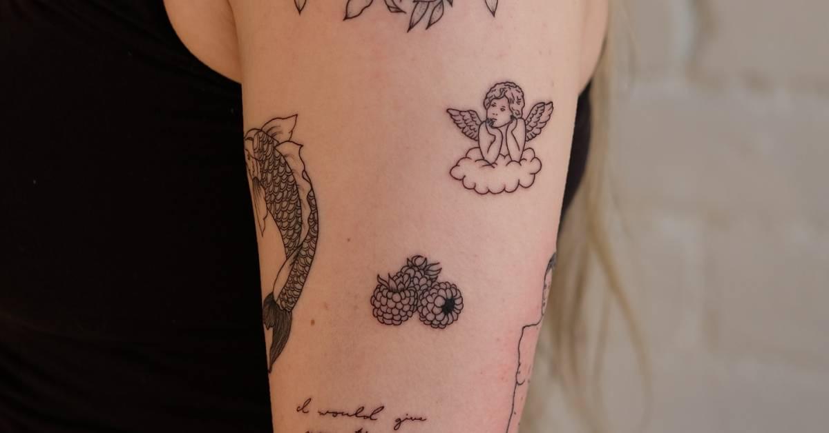 Upper arm composition tattoo in fine line style.