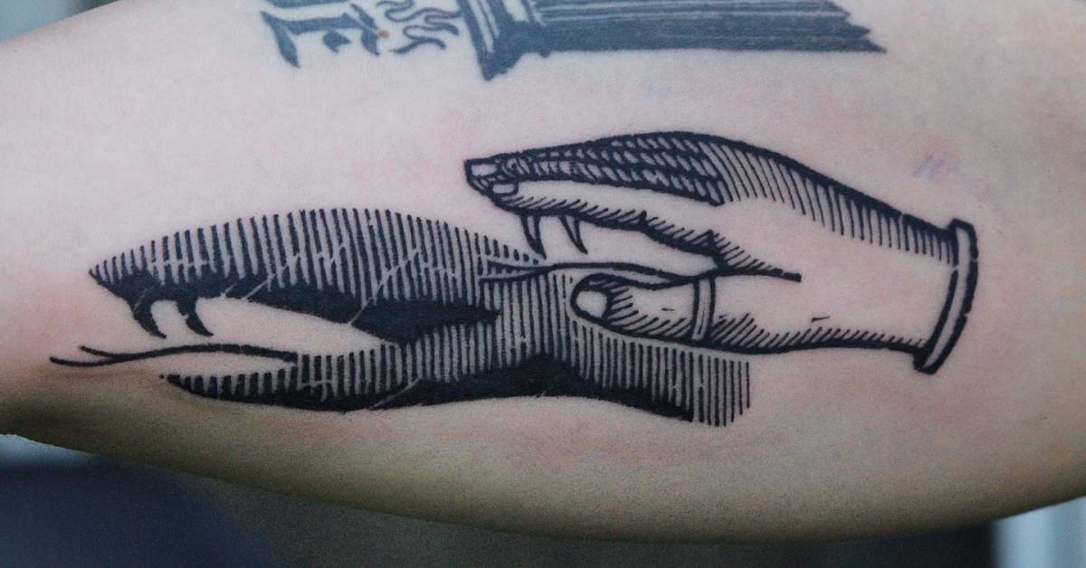 Hand and snake shadowgraphy tattoo located on the iner
