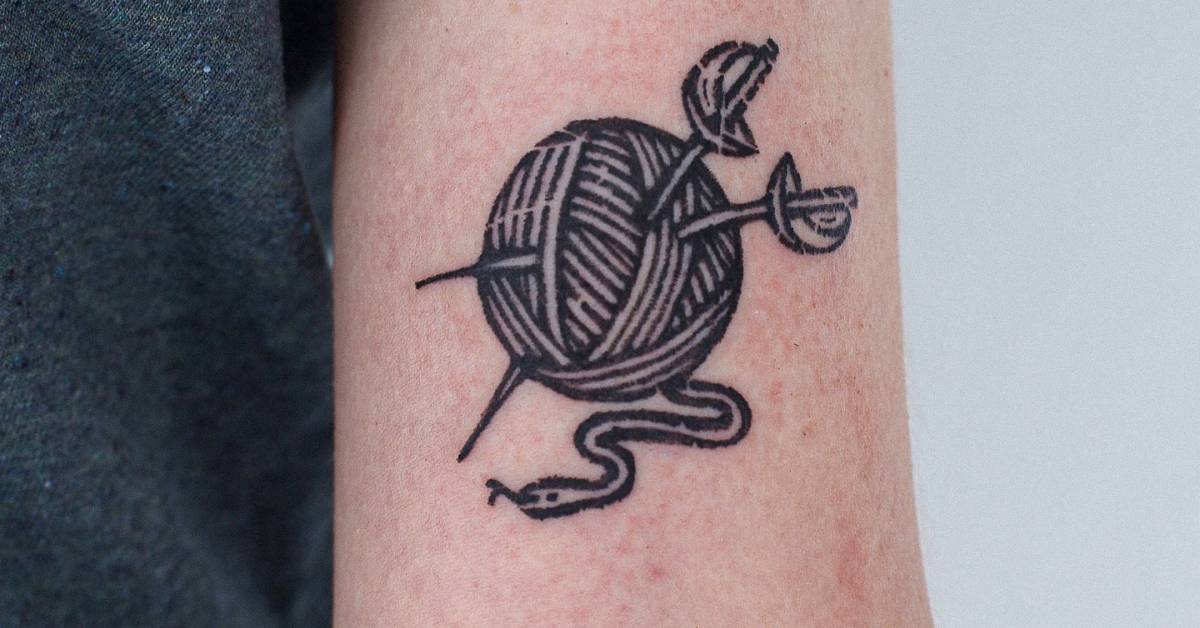 Wool yarn and swords tattooed on the bicep, blackwork