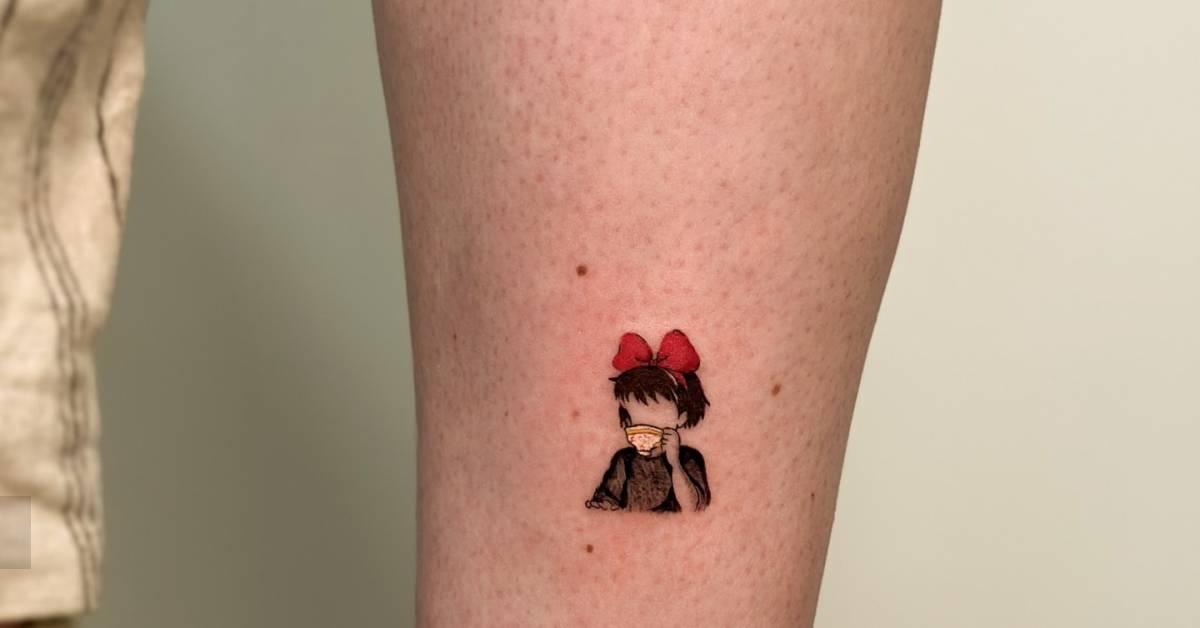 Kiki portrait tattoo in cartoon style done on the shin.