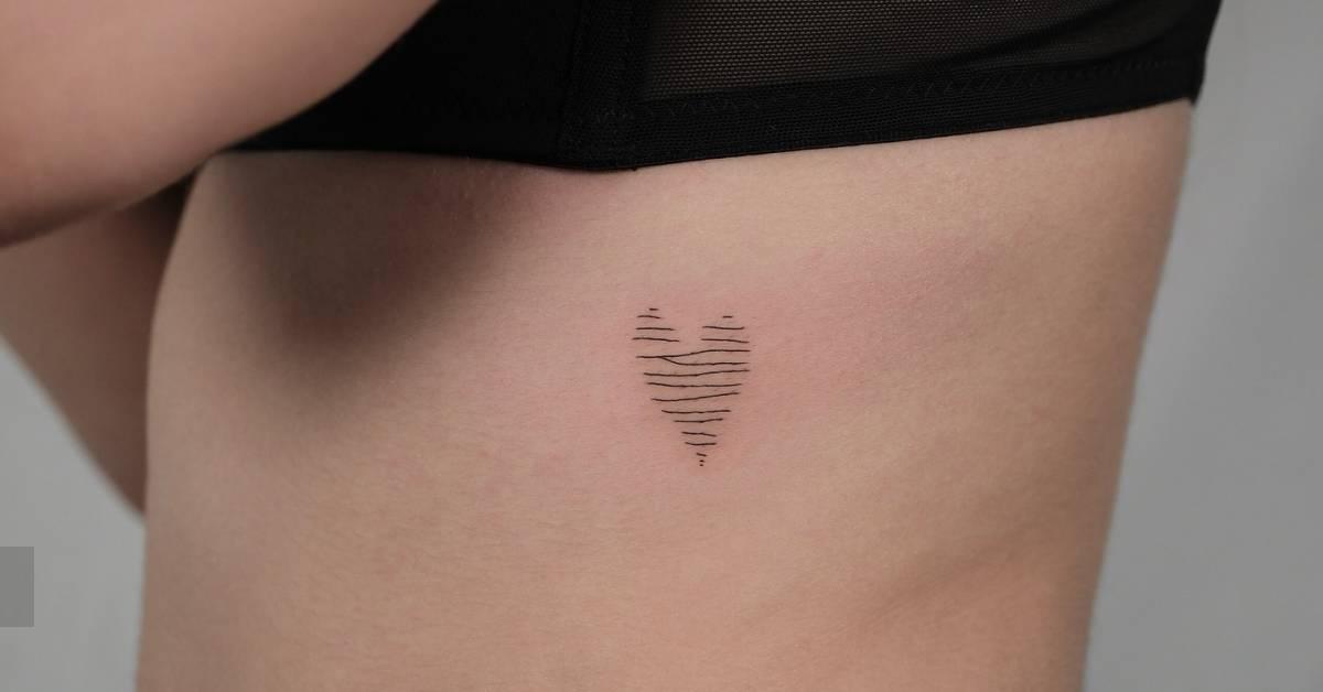 Scribble heart tattoo located on the rib.