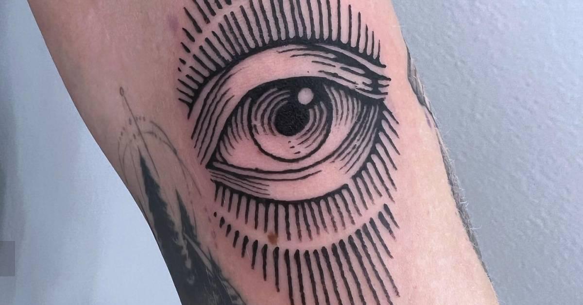 Eye tattoo in engraving style located on the forearm.