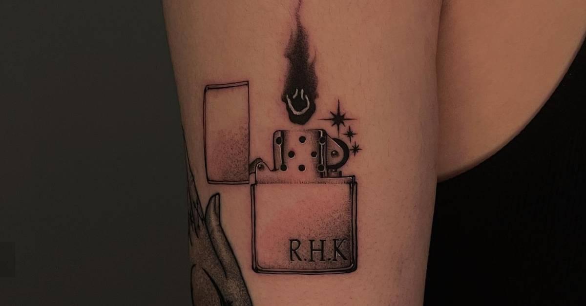 Illustrative style lighter tattoo placed on the tricep.