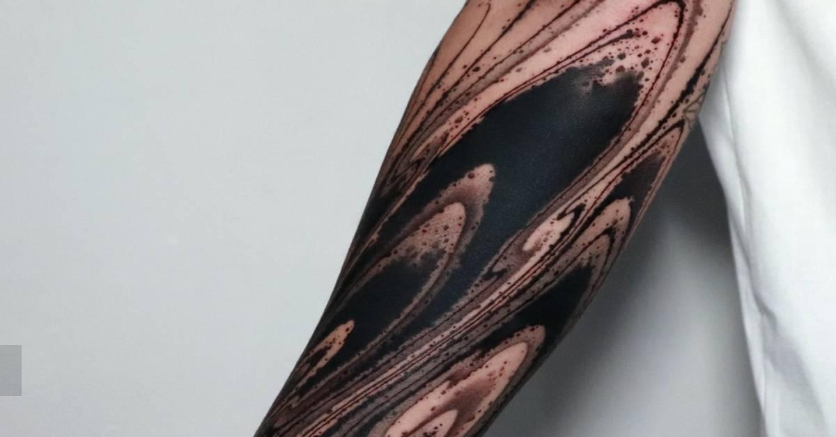 Abstract flow tattoo located on the inner forearm,