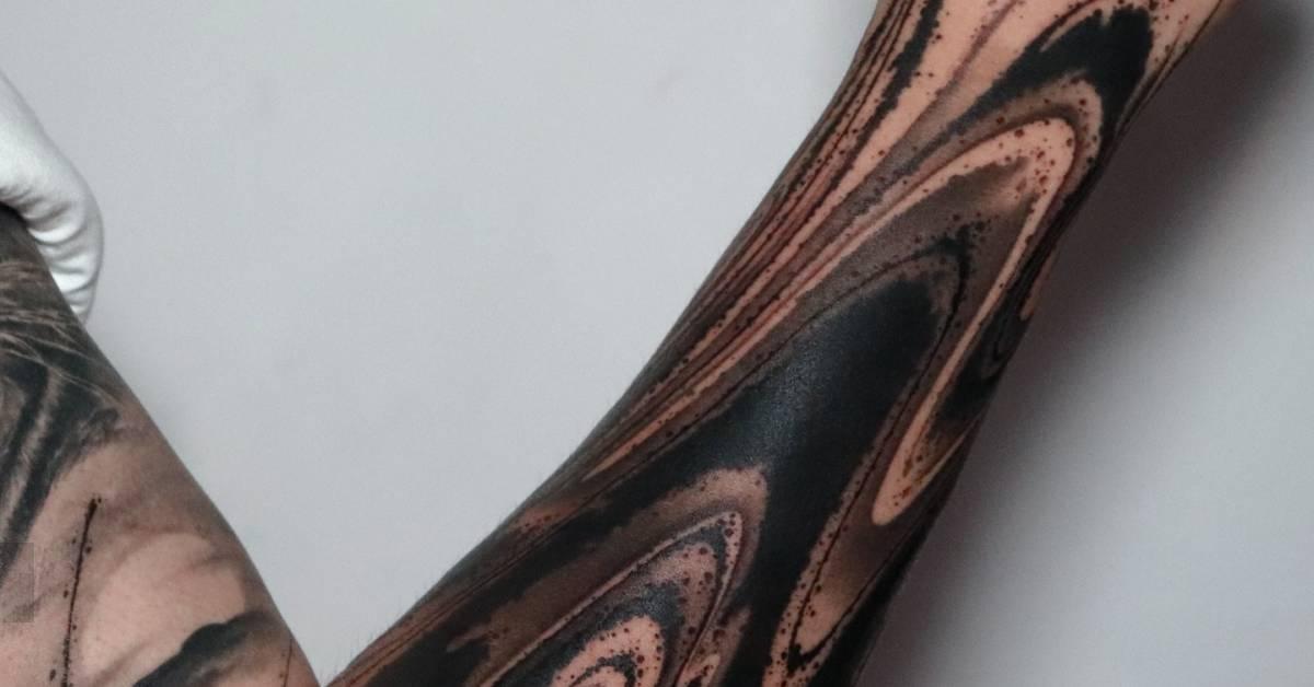 Abstract flow tattoo located on the forearm, blackwork