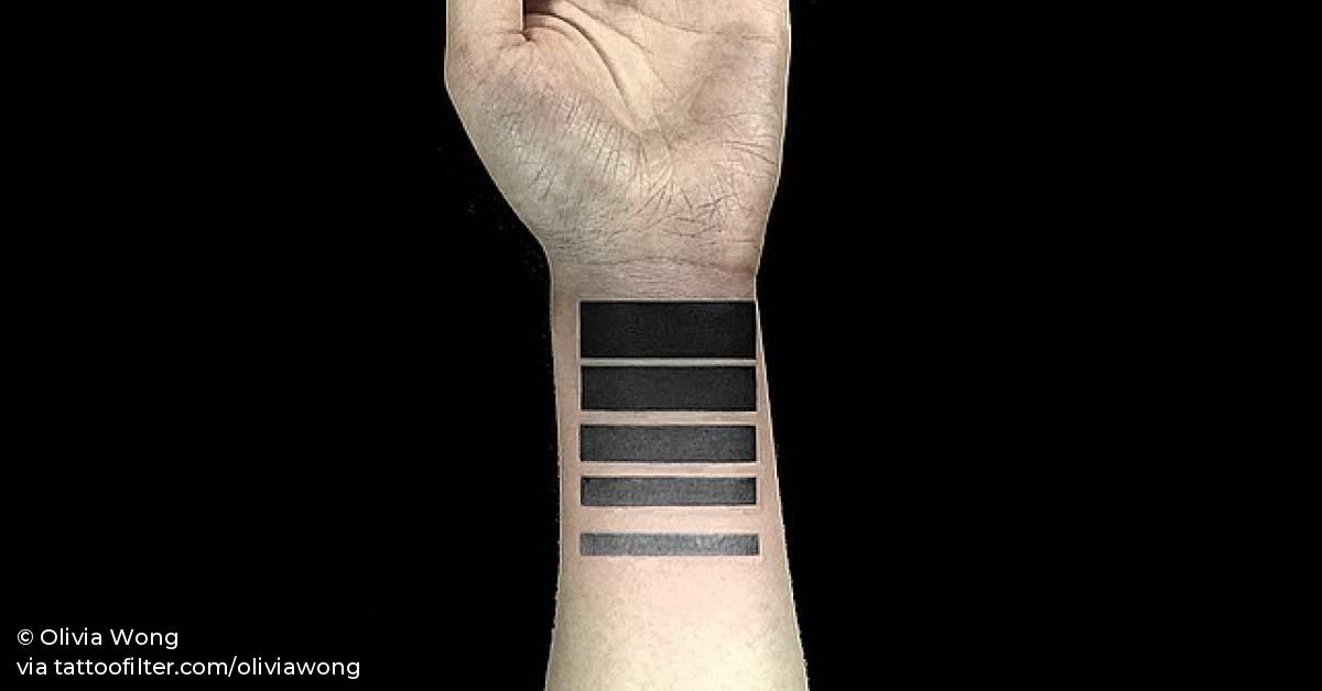 Blackwork/geometric style on the left inner arm.