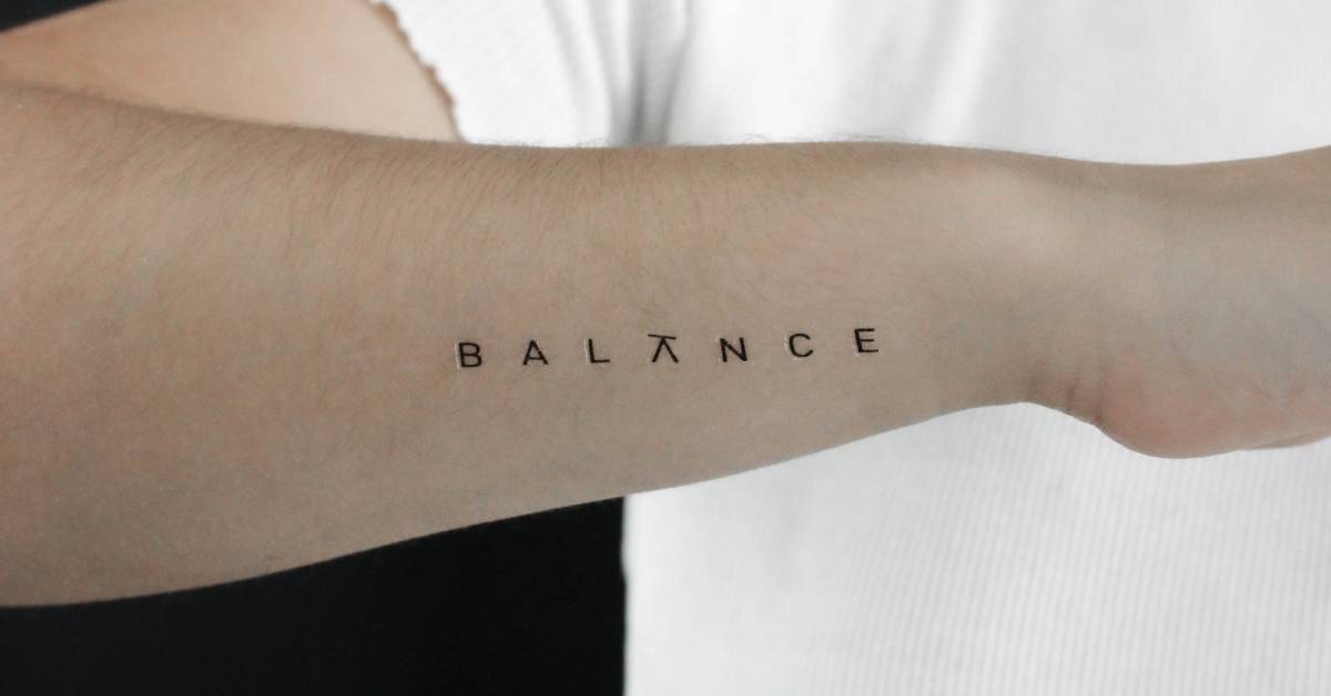 Word "BALANCE" temporary tattoo located on the wrist.