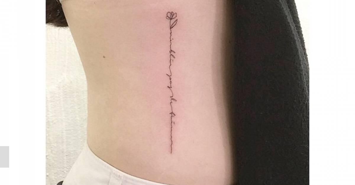 Fine line style flower and handwritten lettering tattoo
