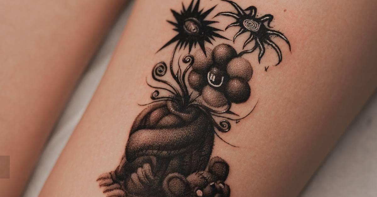 Beheaded teddy bear tattoo located on the thigh.