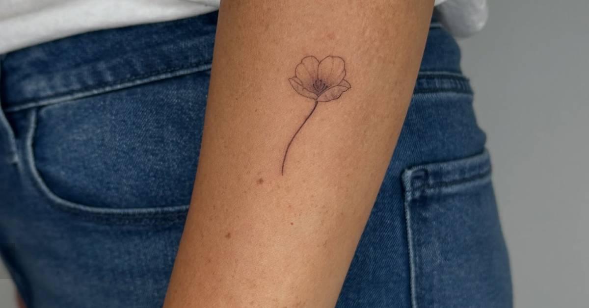 Poppy flower tattoo located on the forearm,