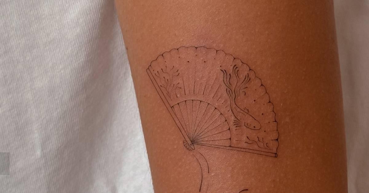 Hand fan tattoo placed on the tricep, done in fine line
