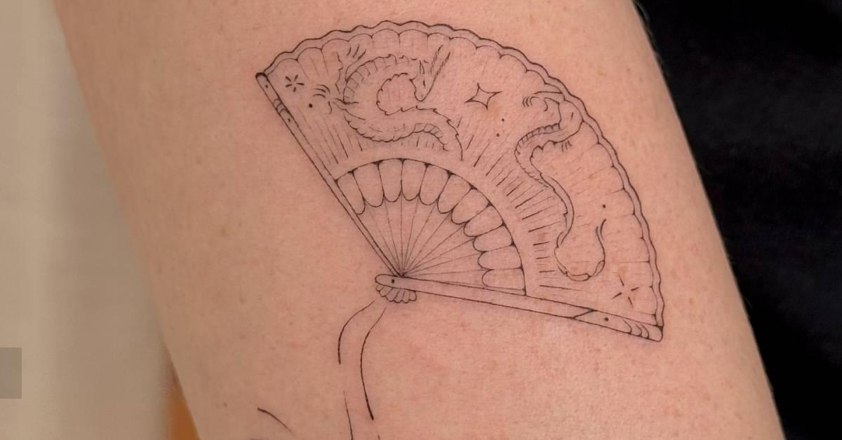 Fine line style hand fan tattoo located on the forearm.