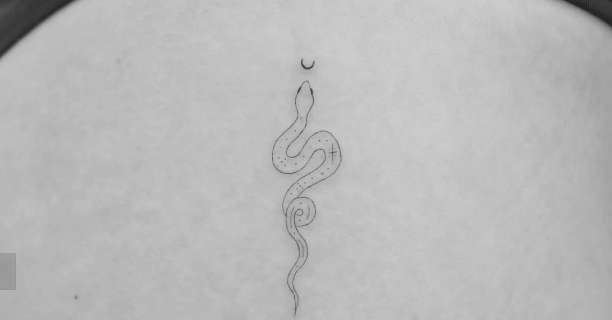 Cute little snake tattoo in fine line style placed on