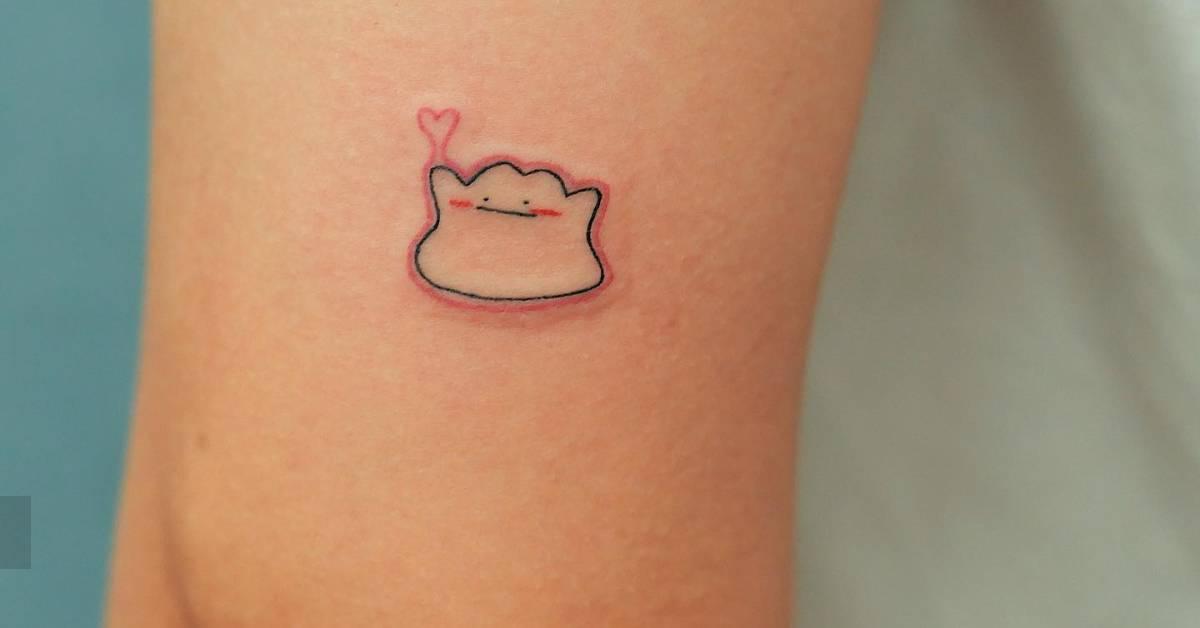 Tiny Ditto tattoo located on the tricep, cartoon style.