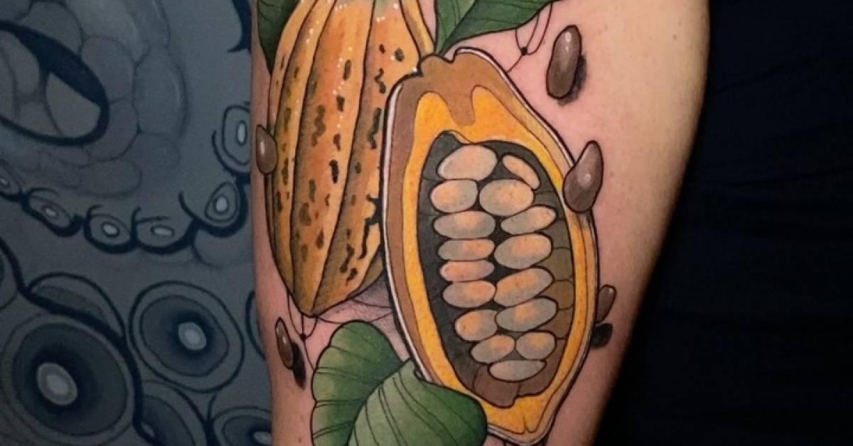Neotraditional cocoa pod tattoo on the upper arm.
