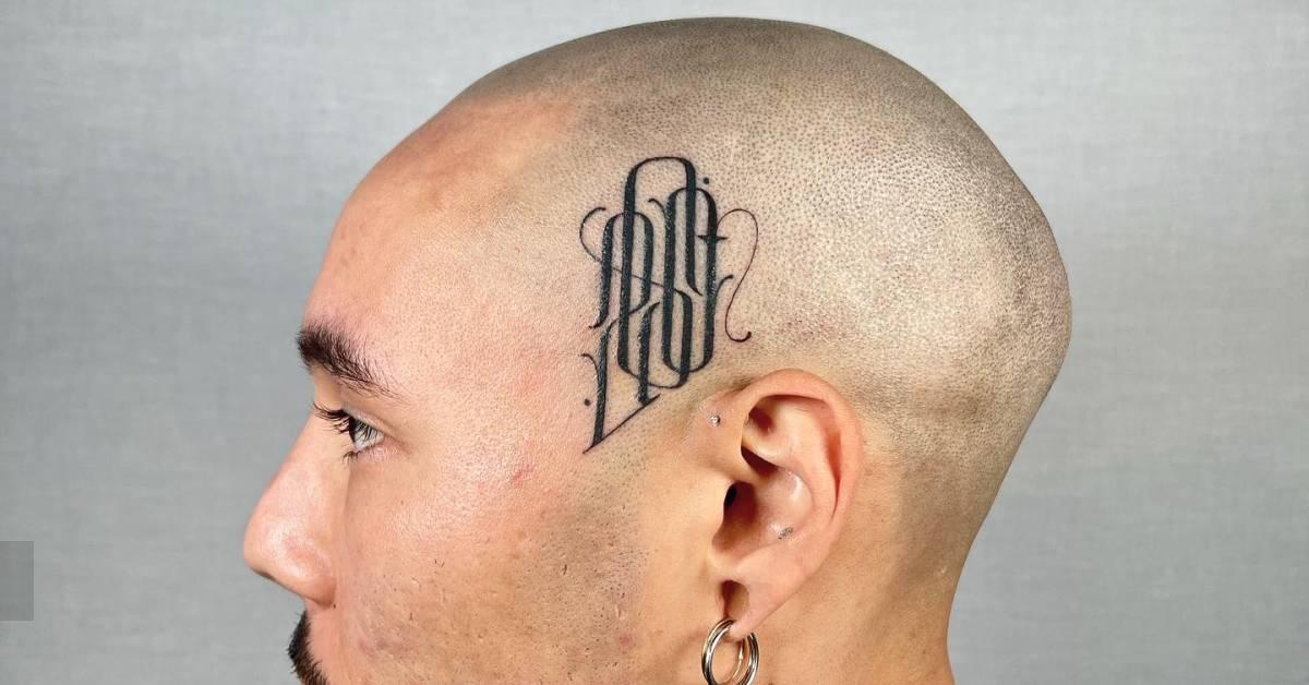 Monogram tattoo located on the side of the head.