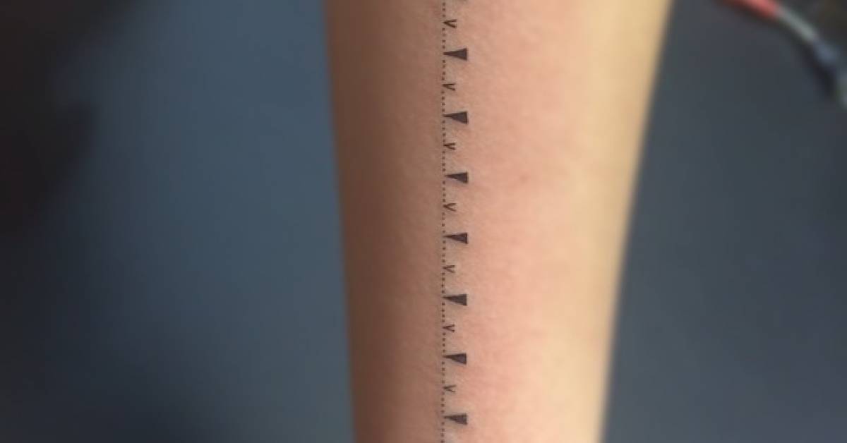 Ruler tattoo on the forearm.