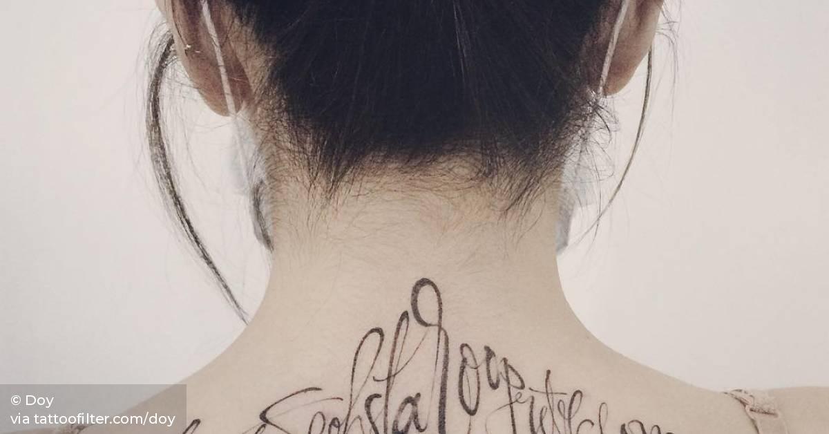 Lettering tattoo on the upper back.