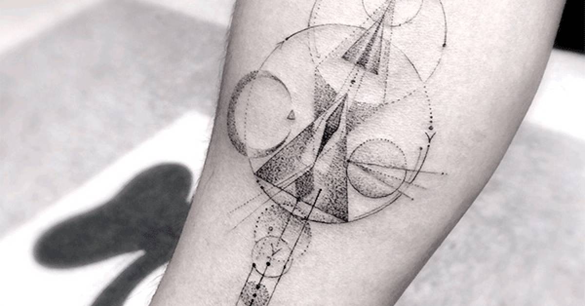Fine line style geometric tattoo on the forearm.