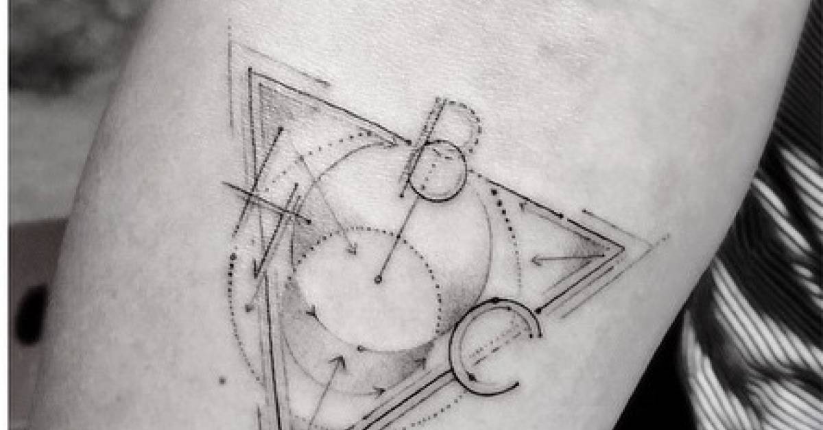 Fine line style triangle tattoo on the right forearm.