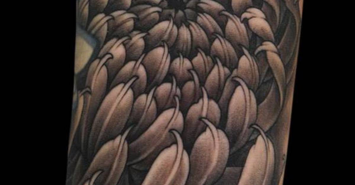 Black and grey style chrysanthemum tattoo on the left