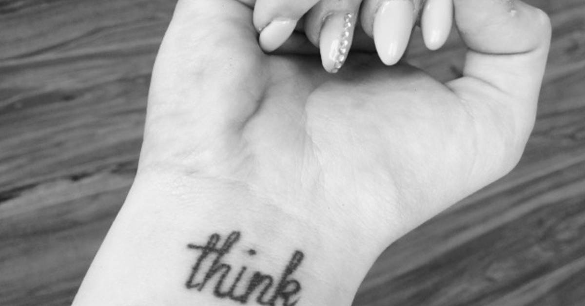 "Think positive" tattoo on Chels' wrist.