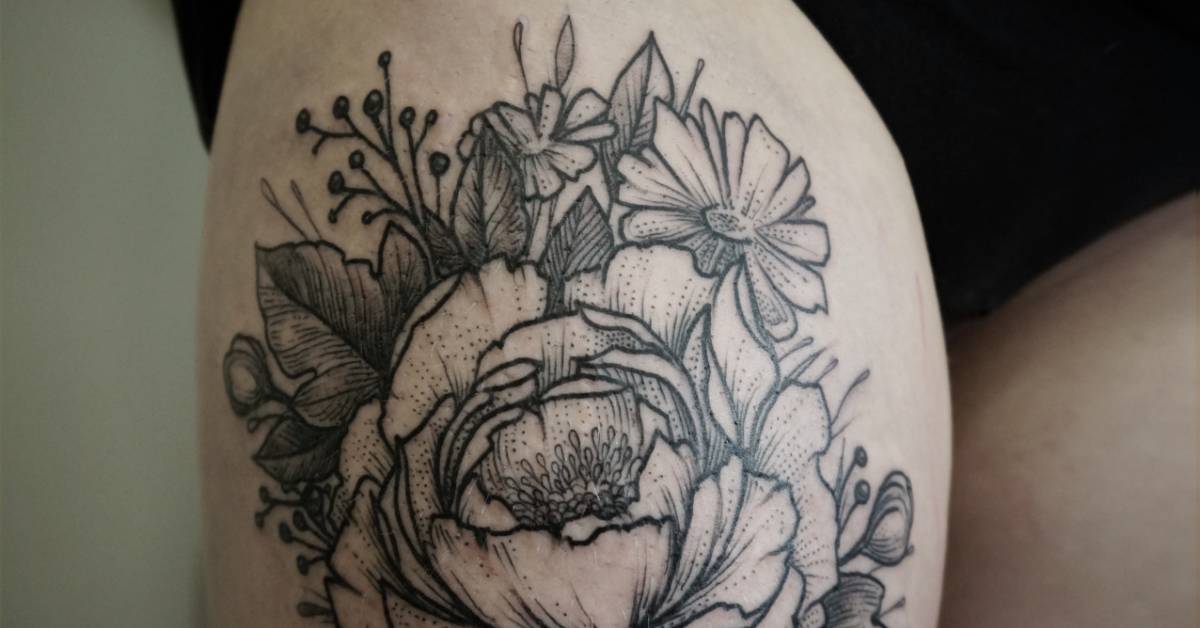 Blackwork/illustrative style peony tattoo on the right