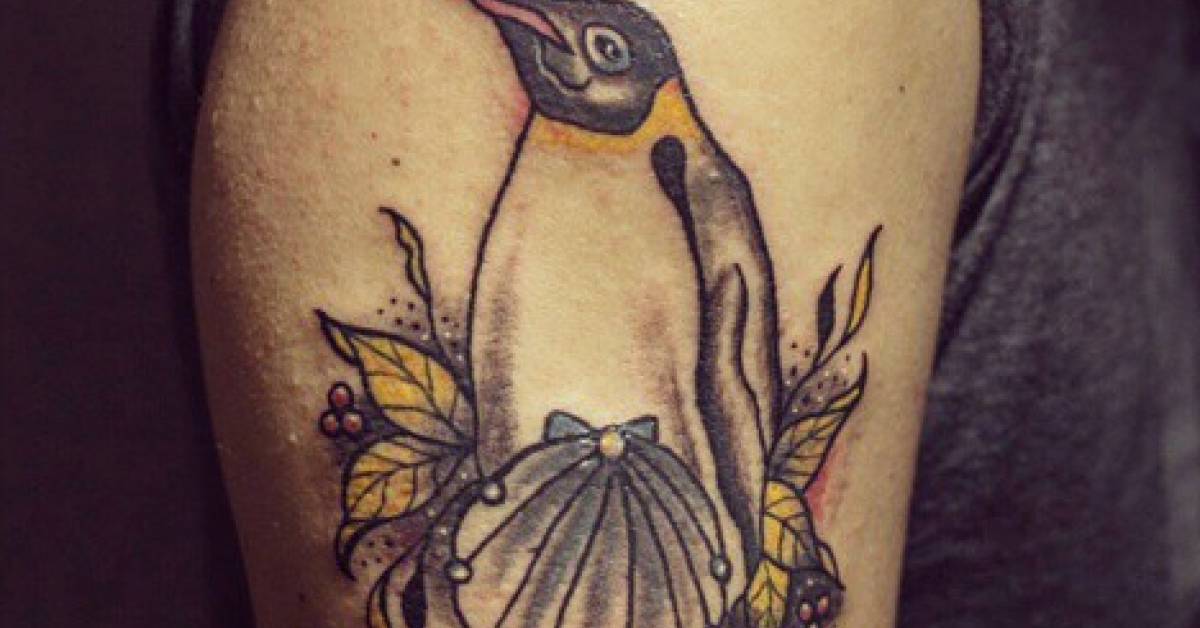 Neotraditional style penguin tattoo on the right upper