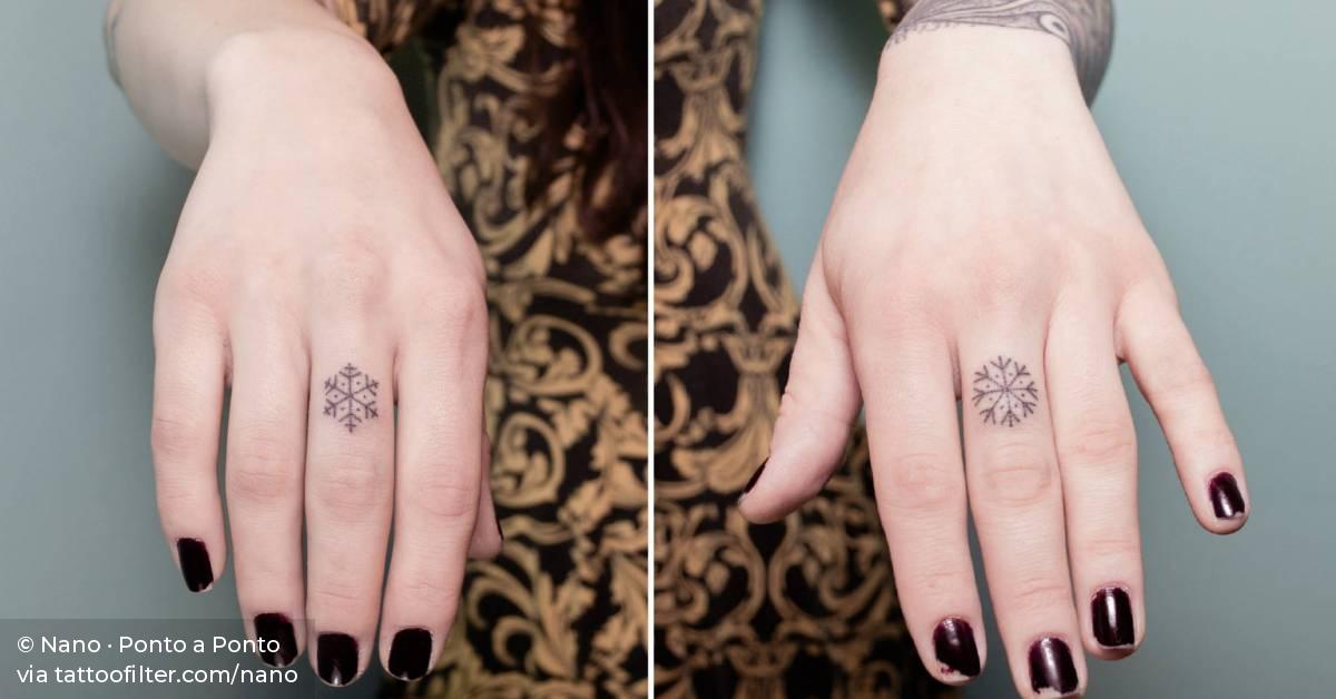 Hand poked snowflakes on both middle fingers.